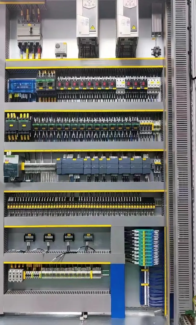 Why should the emergency stop in the PLC program be written